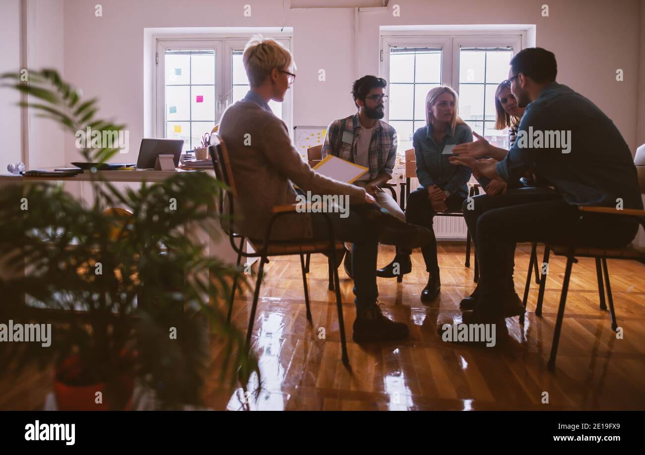 Young people with problems having a discussion while sitting together ...