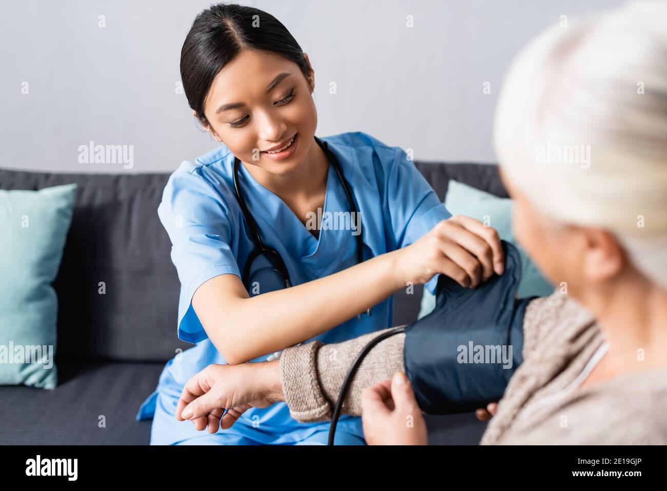 Asian nurse tonometer measuring senior hi-res stock photography and ...