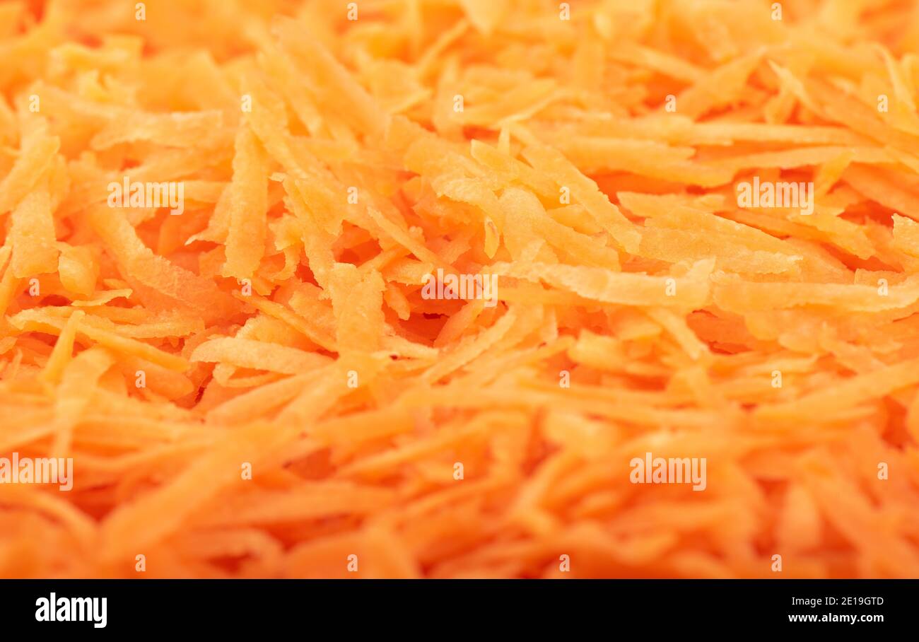 Soft focus. Full frame of grated carrots. The texture of grated carrots ...