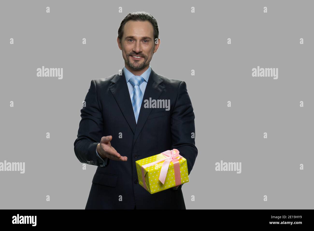Cheerful businessman showing gift hi-res stock photography and images ...