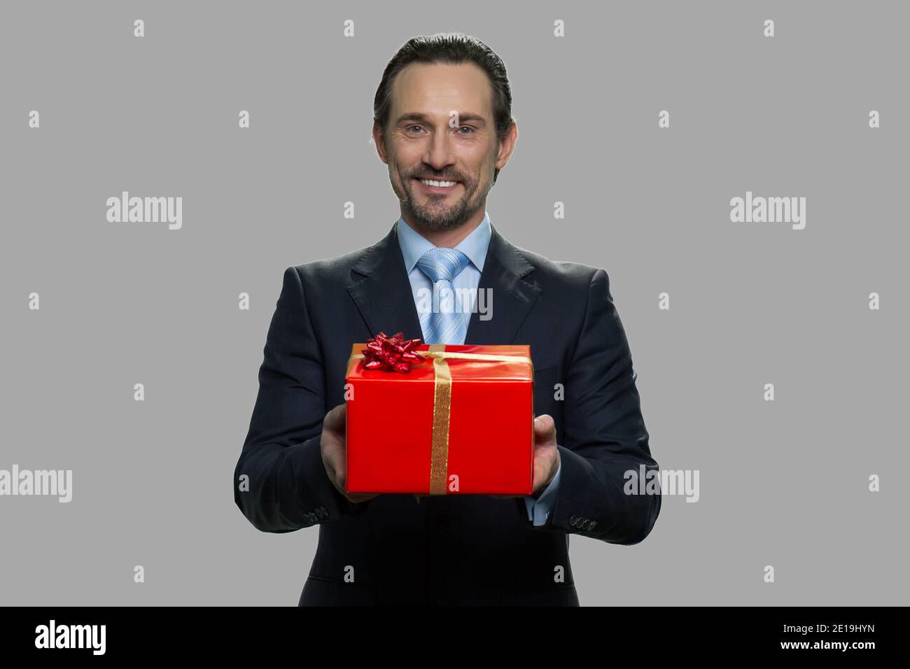 Cheerful aged male presenting gift hi-res stock photography and images ...