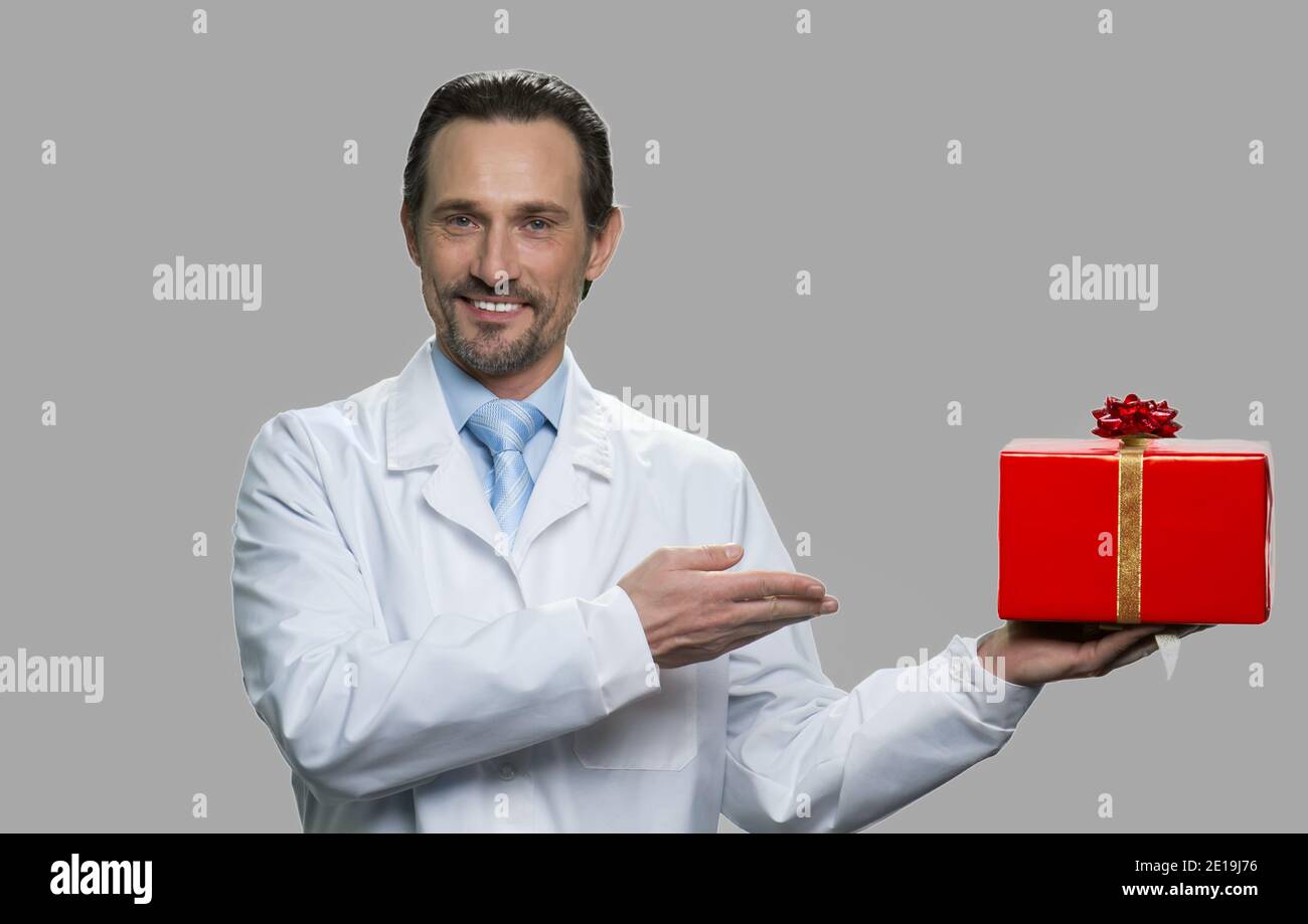 Portrait of smiling scientist showing gift box Stock Photo - Alamy