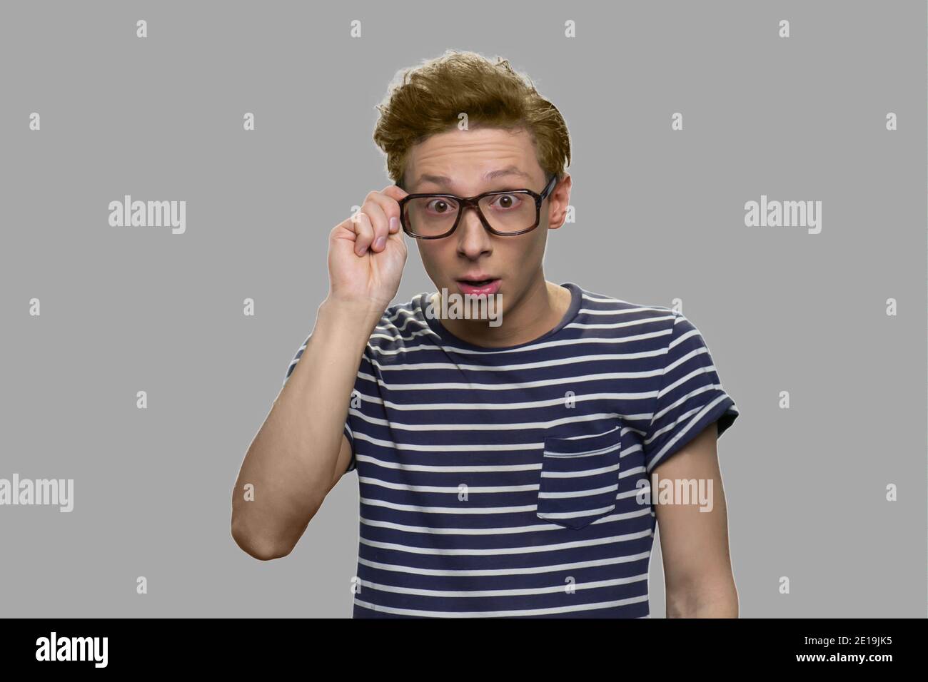 Nerd boy in eyeglasses with surprised facial expression Stock Photo - Alamy