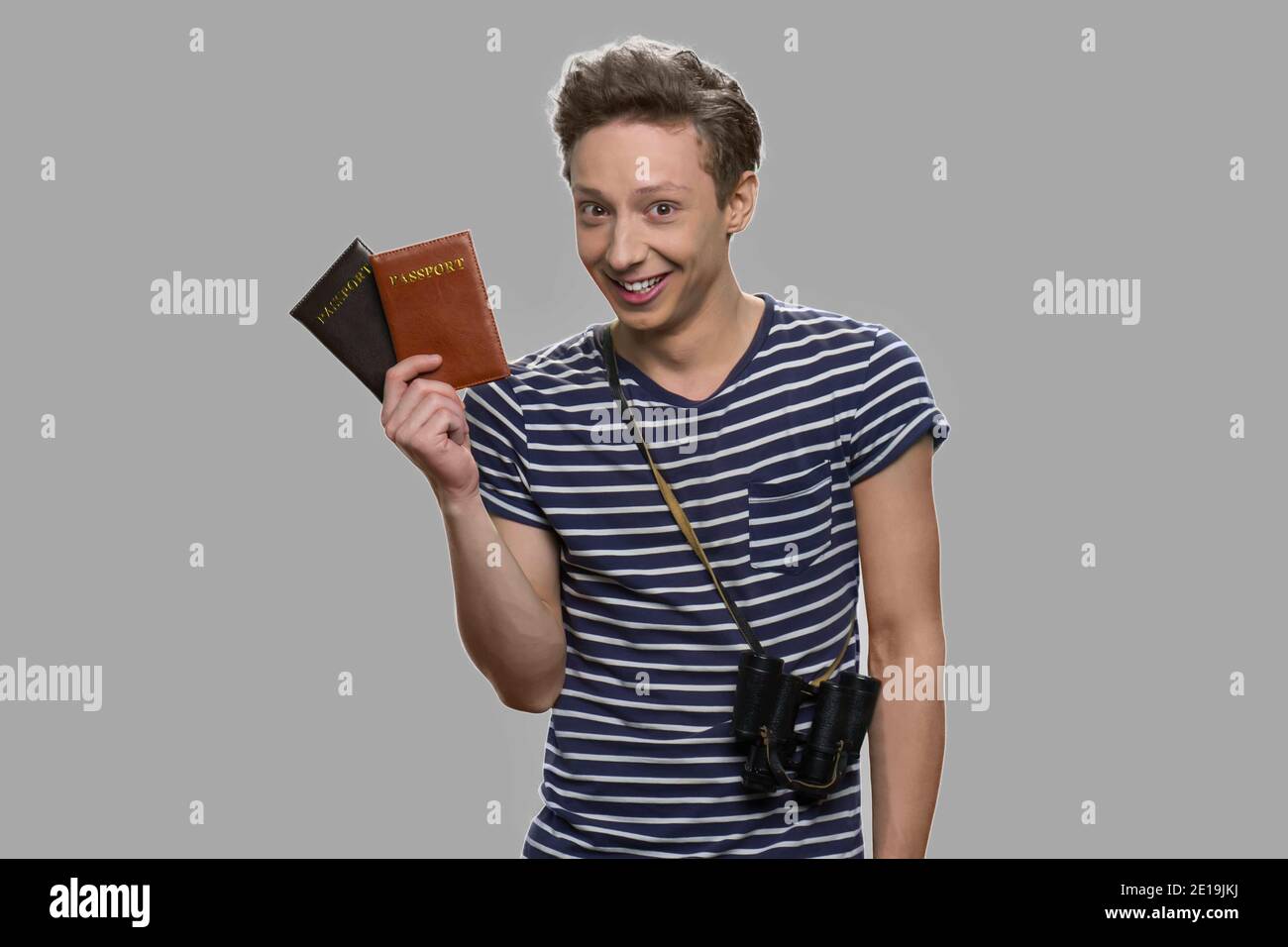 Portrait of joyful teen boy showing his passports Stock Photo - Alamy