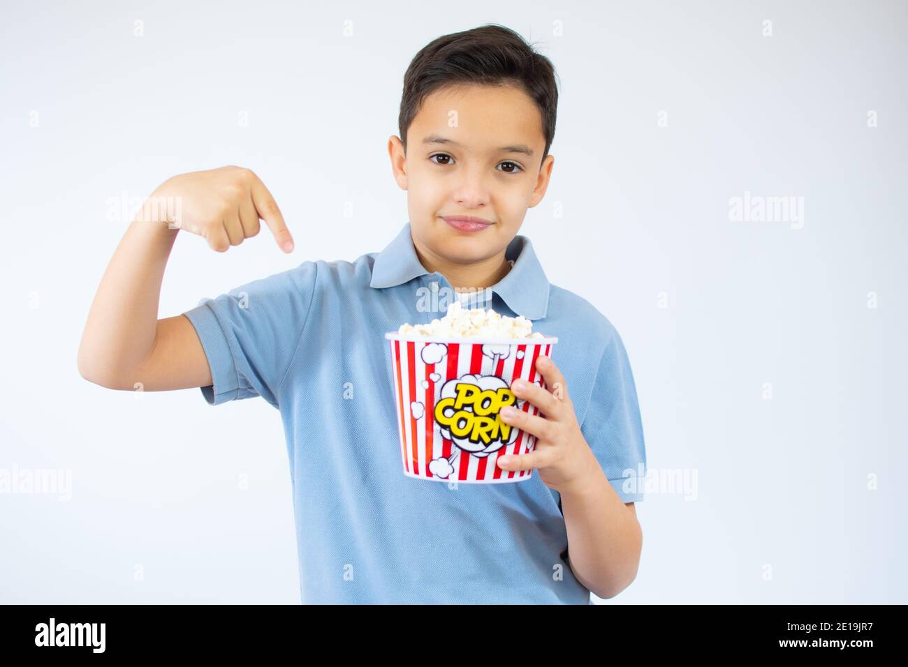 Young caucasian child with popcorn on white background Stock Photo - Alamy