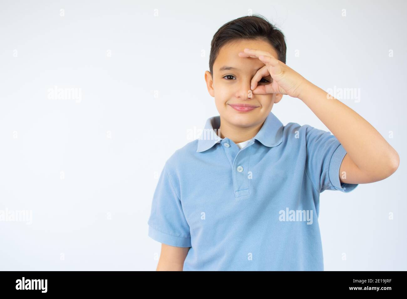 Cheerful young boy showing OK sign isolated on white background Stock ...