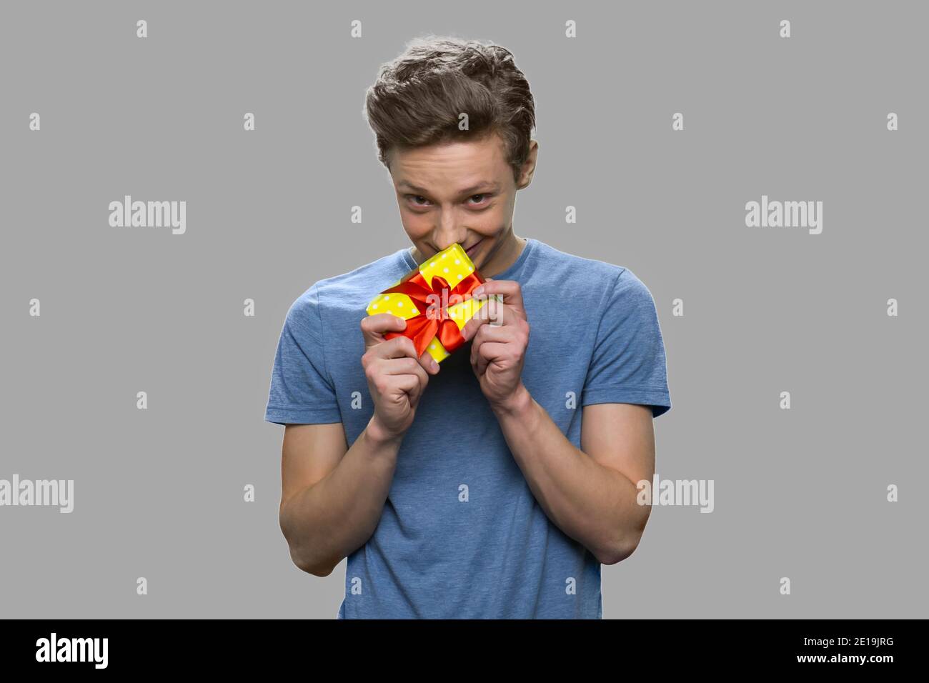 Shy teen boy holding small gift box Stock Photo - Alamy