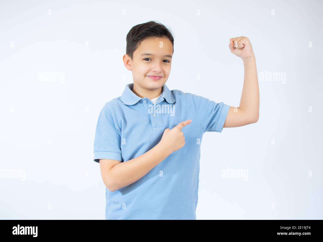 Boy is showing his arm muscles over white background Stock Photo - Alamy Boy is showing his arm muscles over white background Stock Photo - Alamy