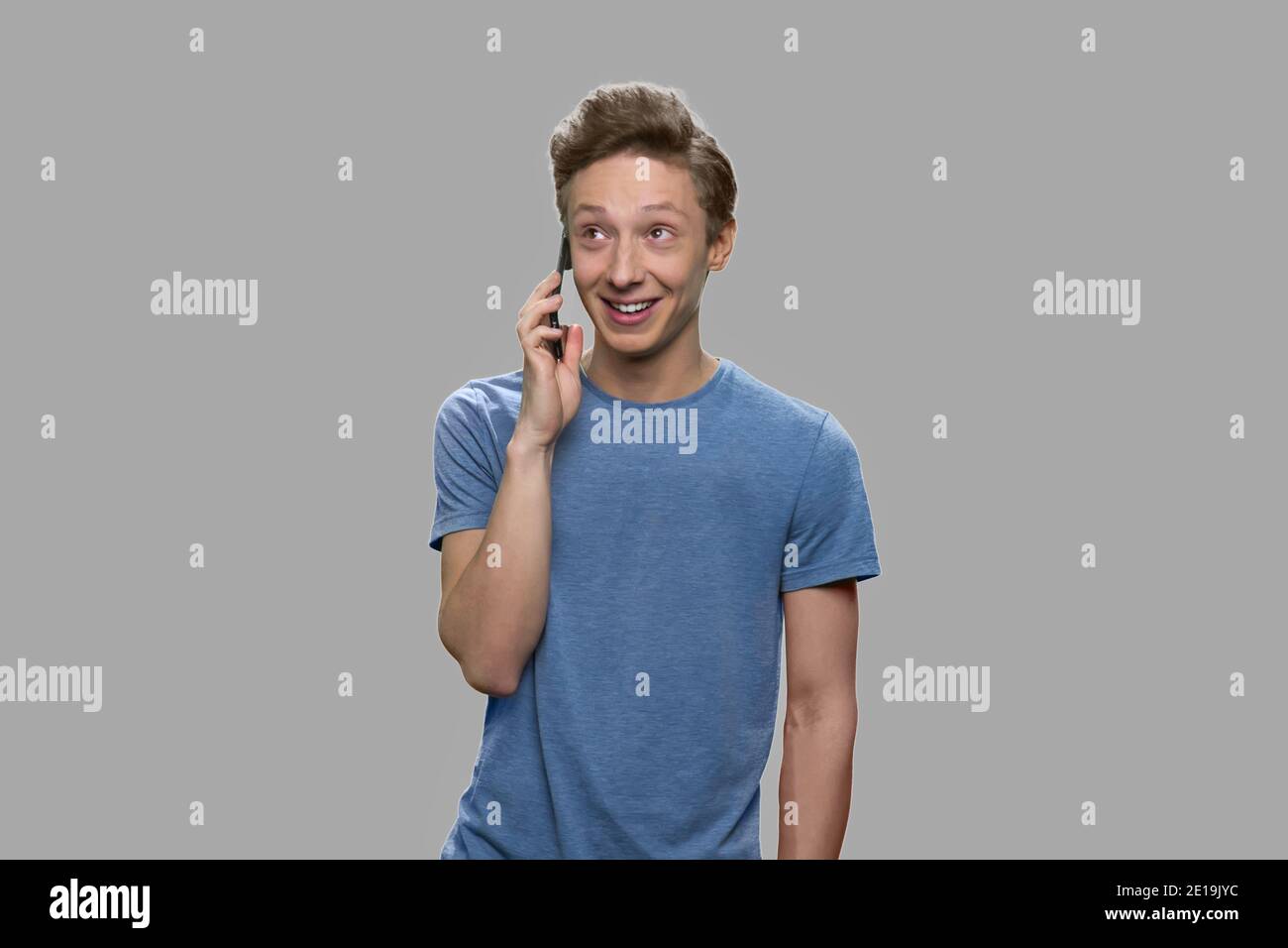 Happy teen boy talking on mobile phone Stock Photo - Alamy