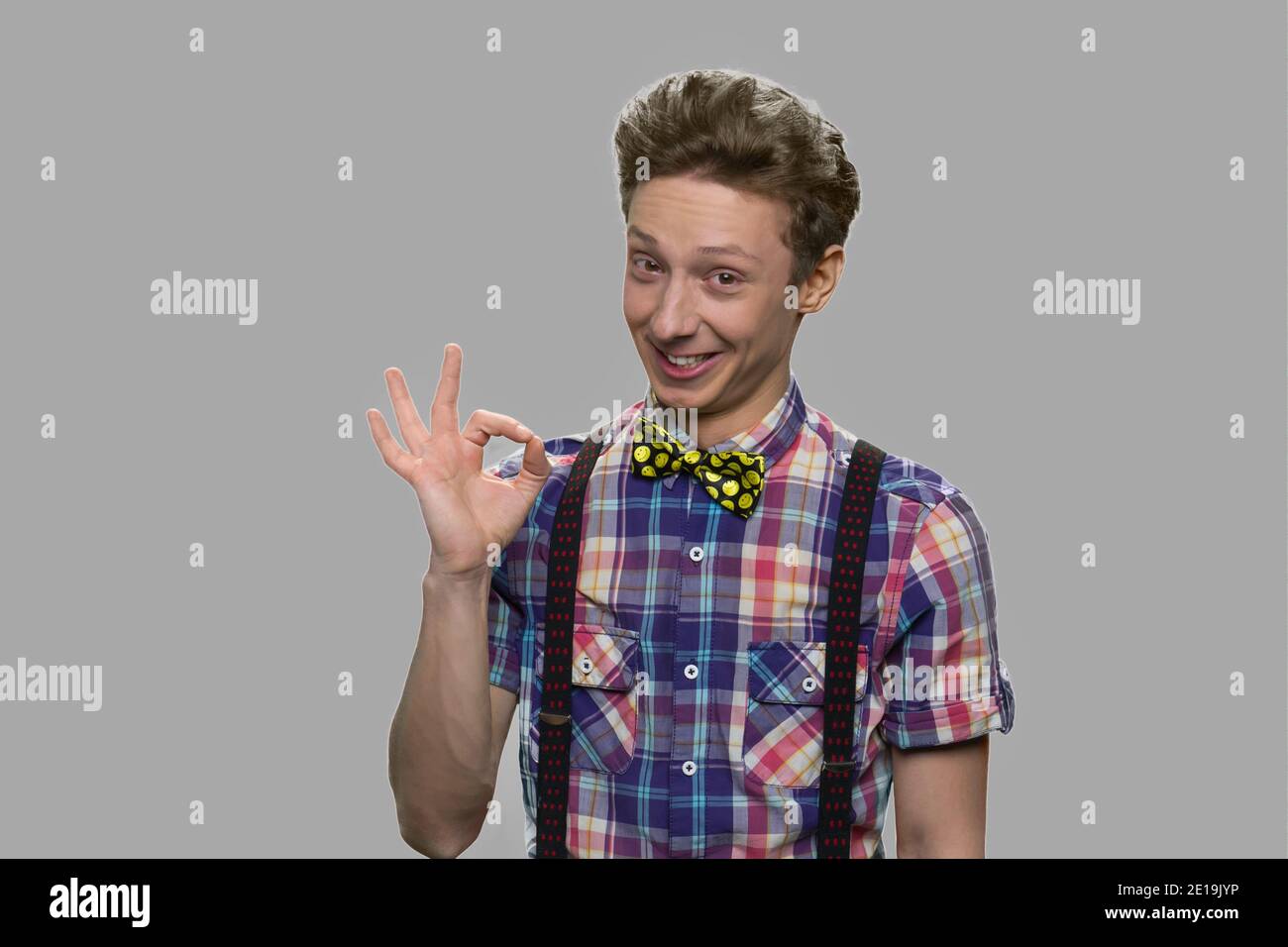 Cute teenage boy showing ok sign Stock Photo - Alamy