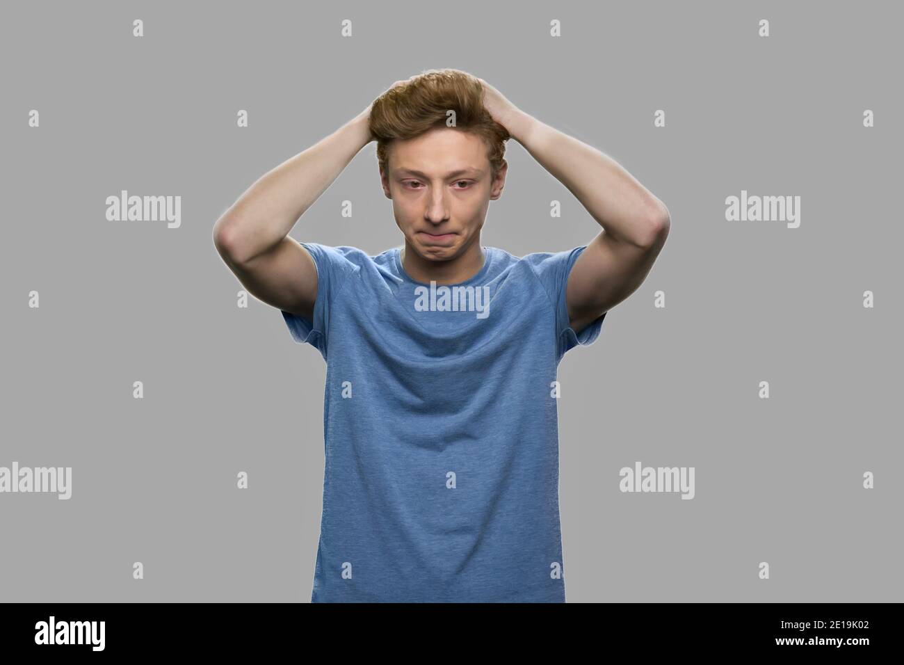 Frustrated teen boy on gray background Stock Photo - Alamy