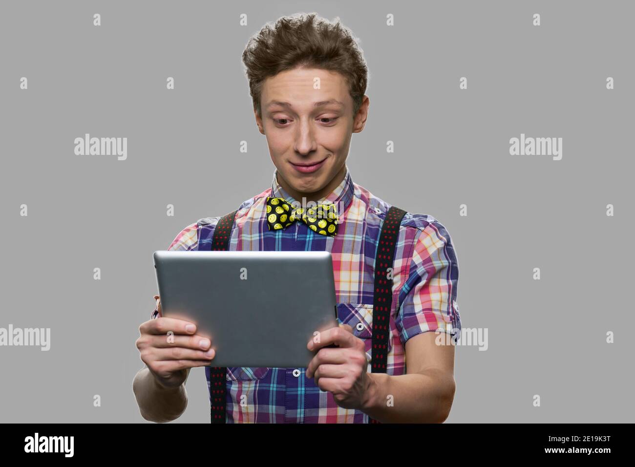 Caucasian teen boy looking at tablet pc Stock Photo - Alamy