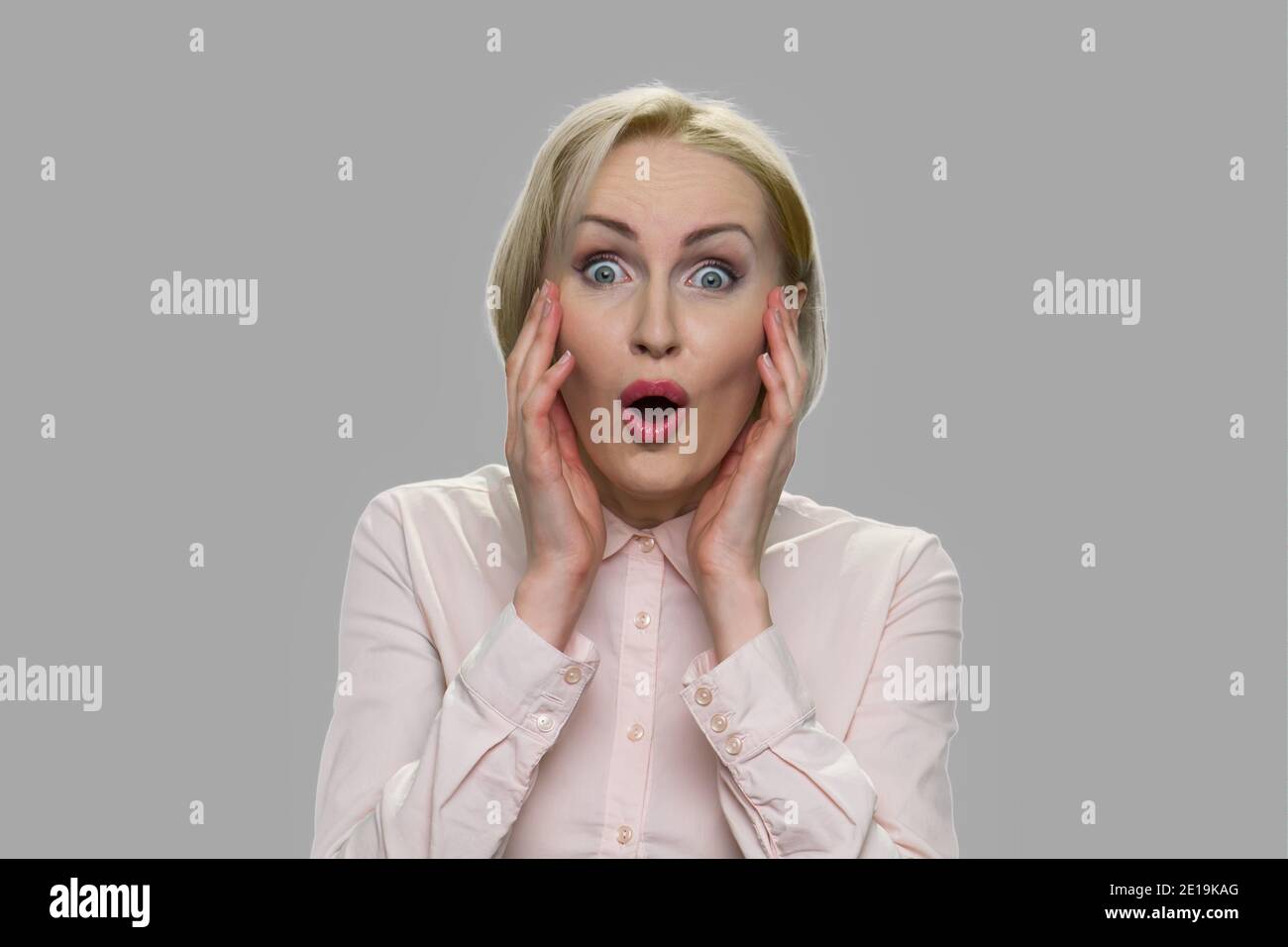 Young pretty woman with shocked expression Stock Photo - Alamy