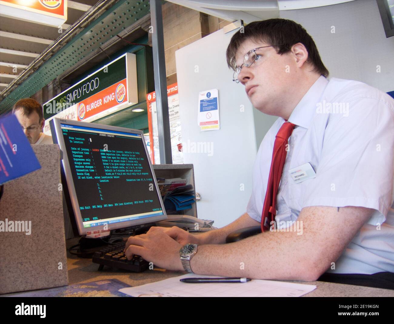 Train station help information desk and assistant Stock Photo - Alamy