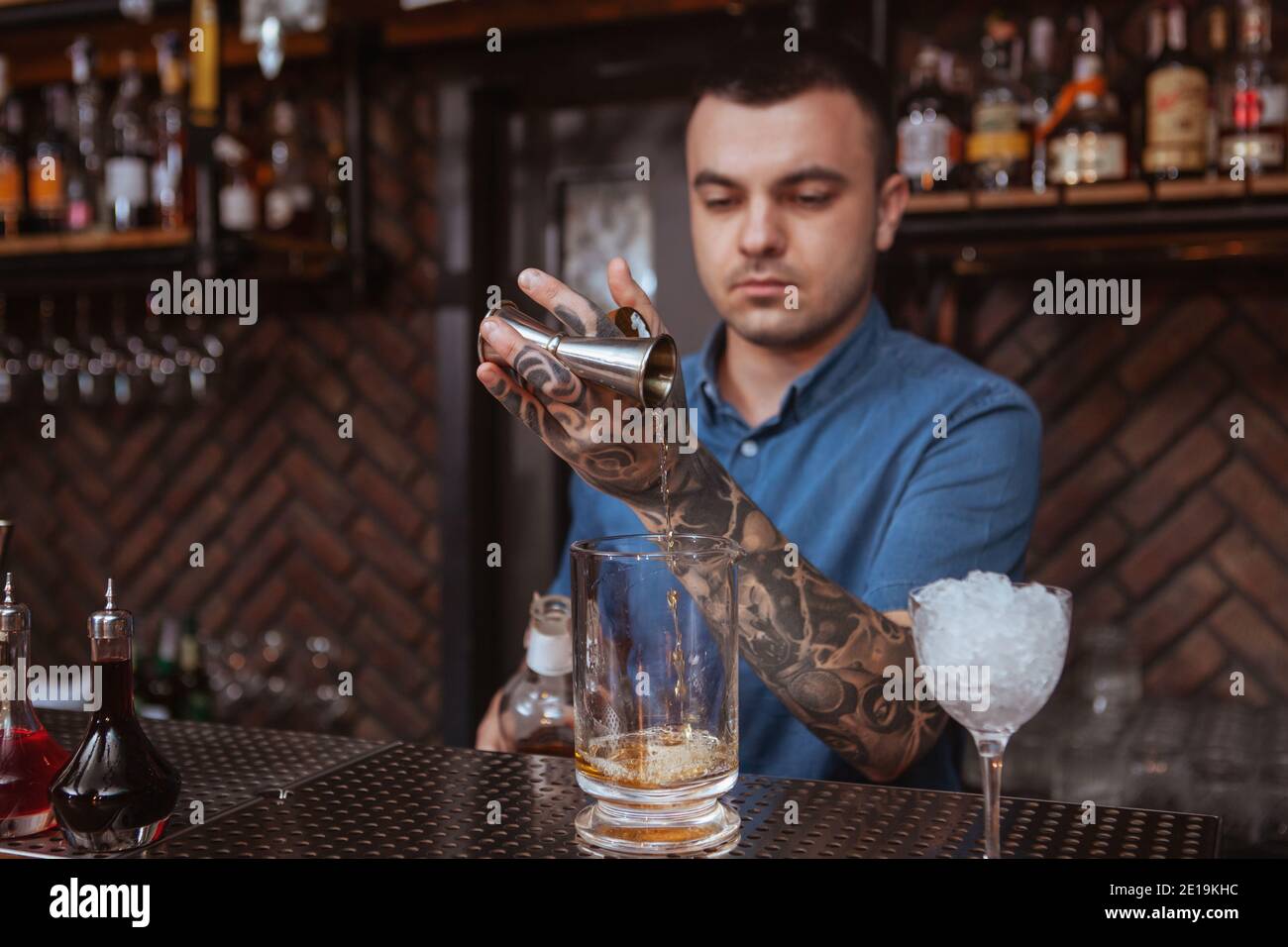 Professional bartender preparing a drink. Handsome male barman mixing ...