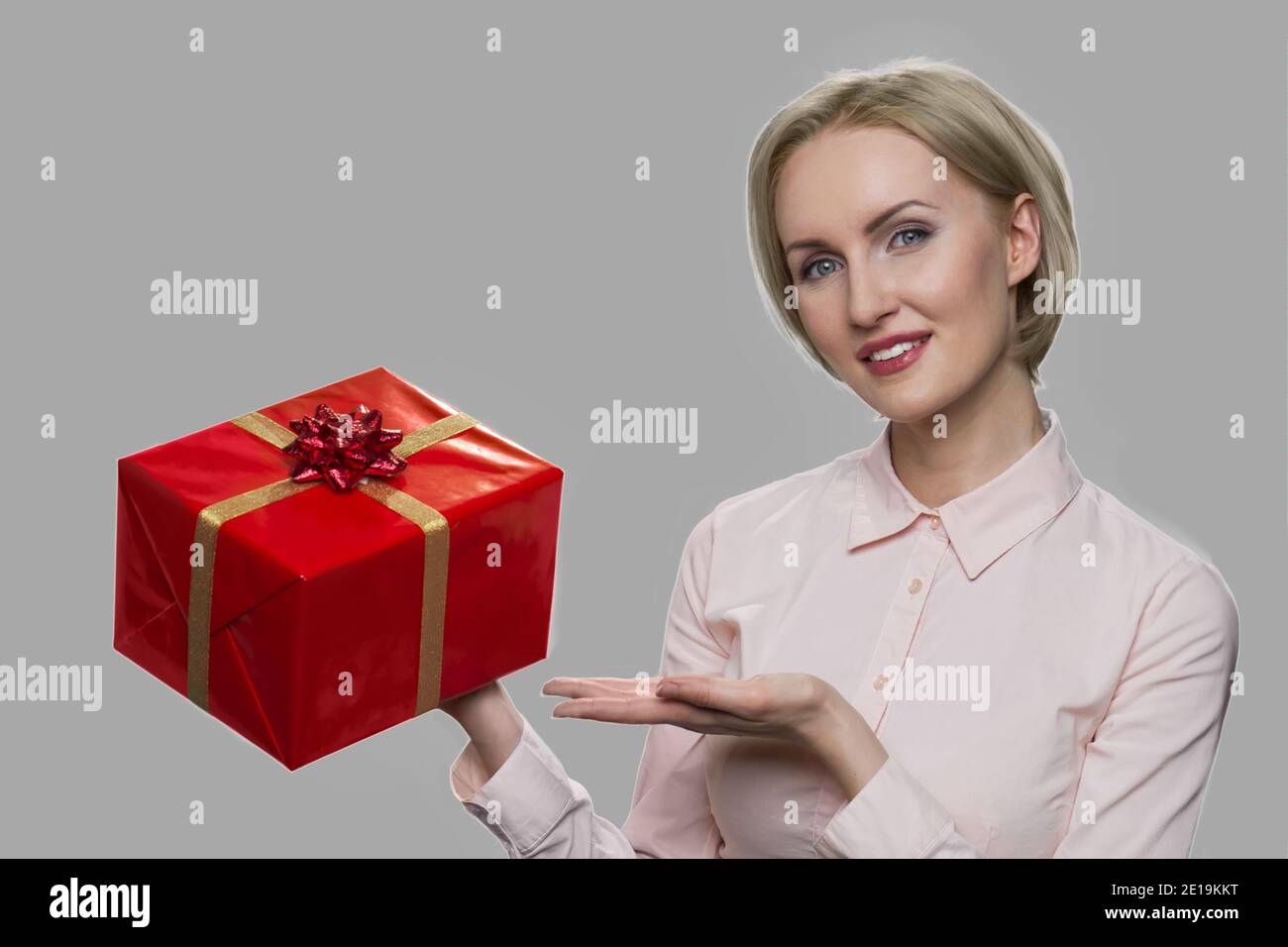 Business woman presenting gift box Stock Photo - Alamy