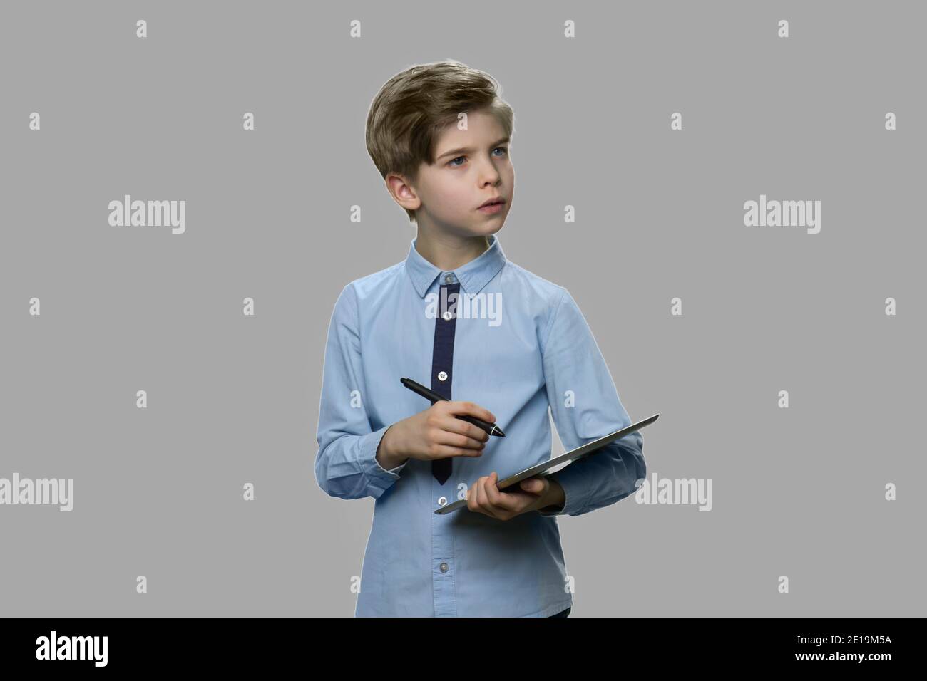 Smart little boy working on tablet device Stock Photo - Alamy