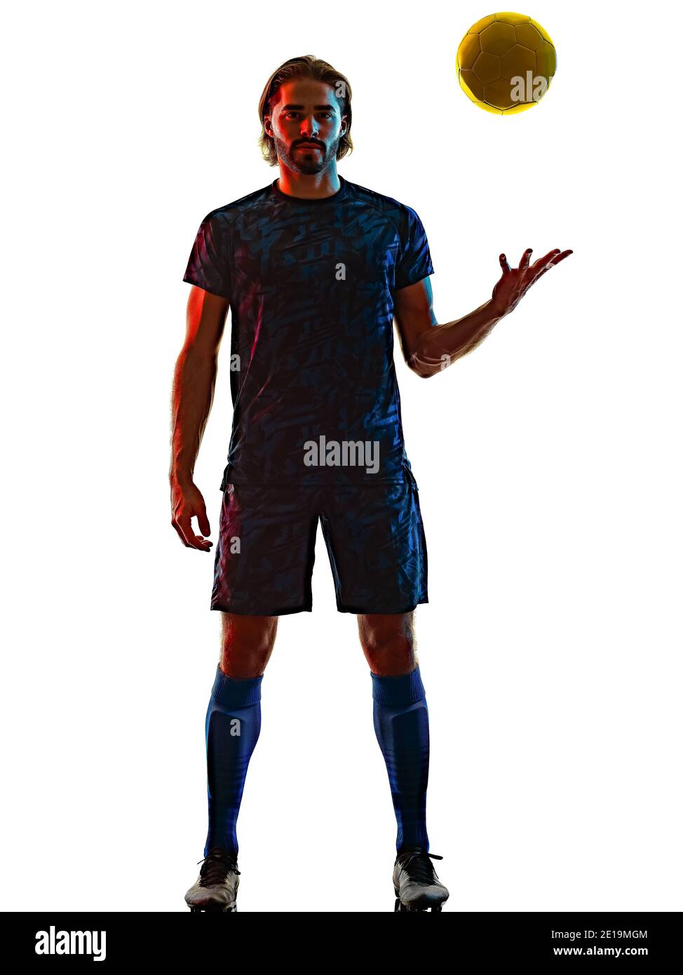 one young caucasian soccer player in studio silhouette shadow isolated ...
