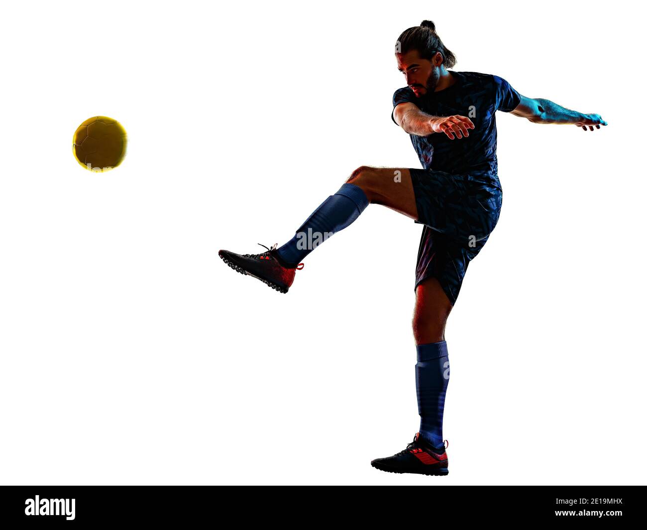 one young caucasian soccer player in studio silhouette shadow isolated ...