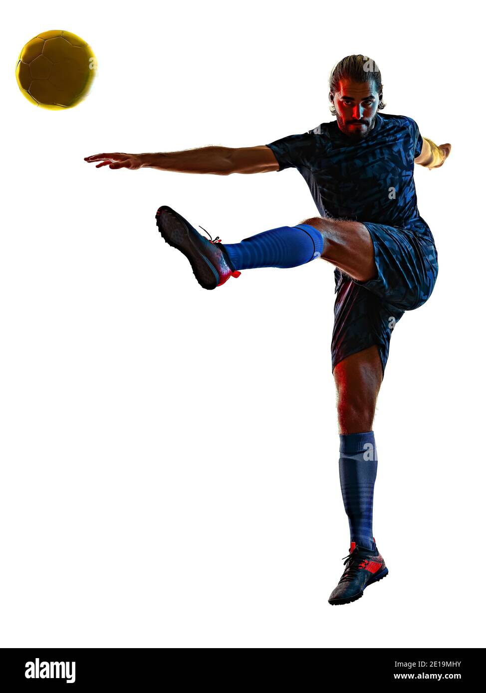 one young caucasian soccer player in studio silhouette shadow isolated ...