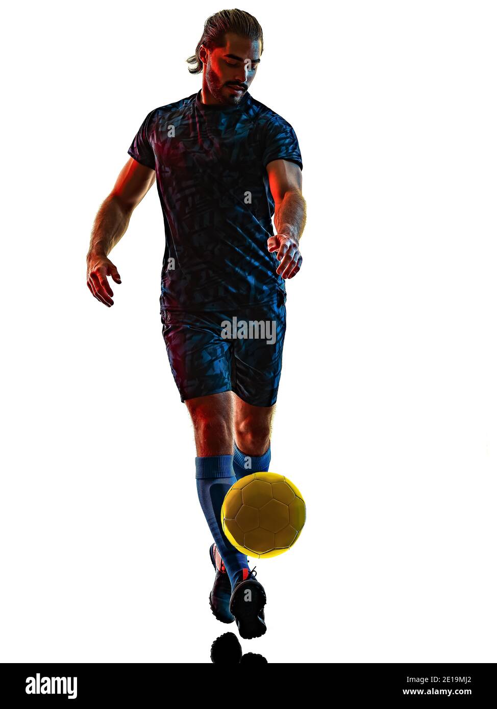 one young caucasian soccer player in studio silhouette shadow isolated ...