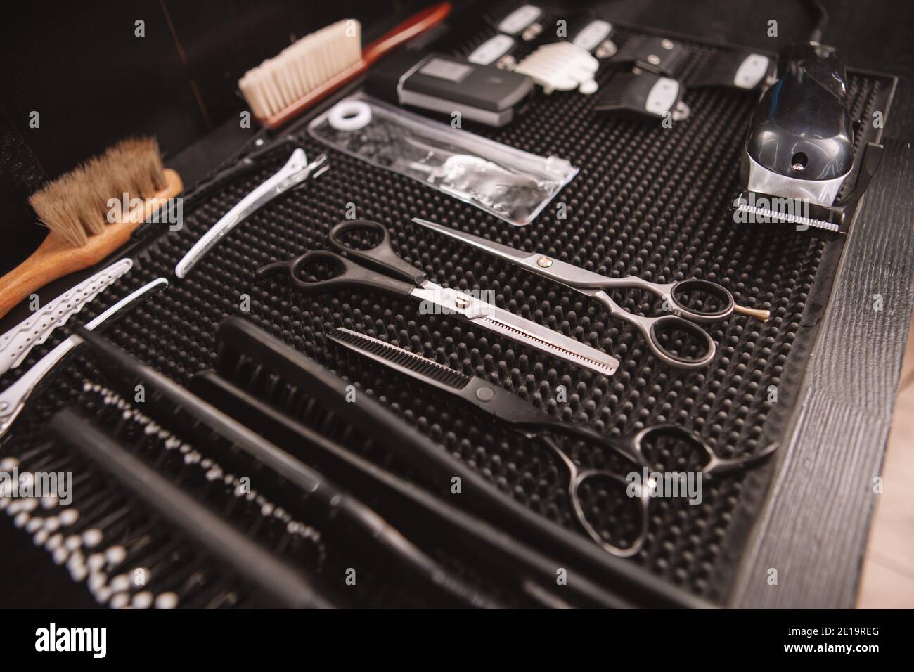 Hairstyling barber tools on the desk at the barbershop. Variety of hair ...