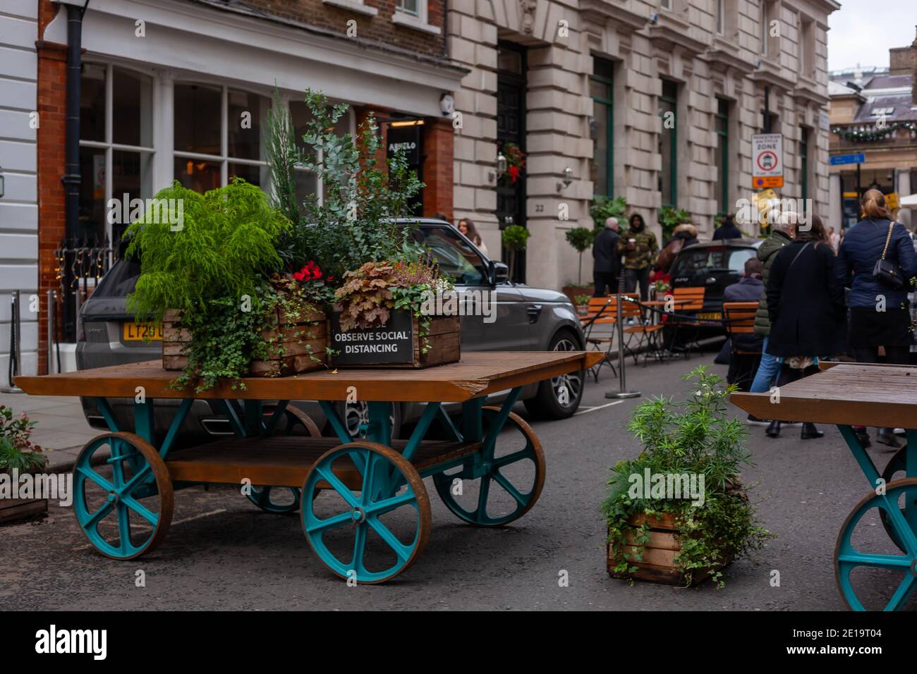 Street side rear view of small crowd gathered near Covent Garden Market ...