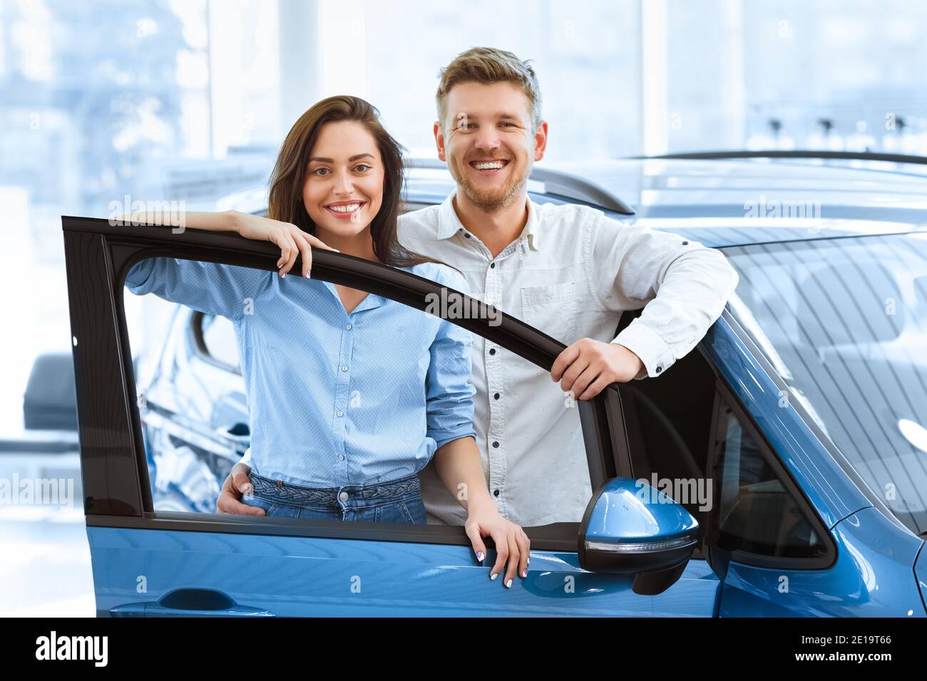 Perfect family car. Shot of a beautiful happy couple posing together ...