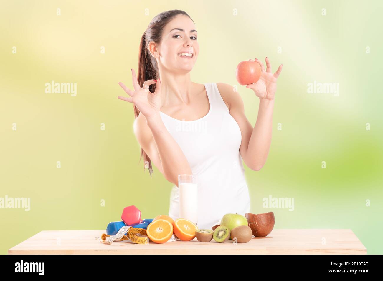 A beautiful slender girl eating healthy fruit close up Stock Photo - Alamy