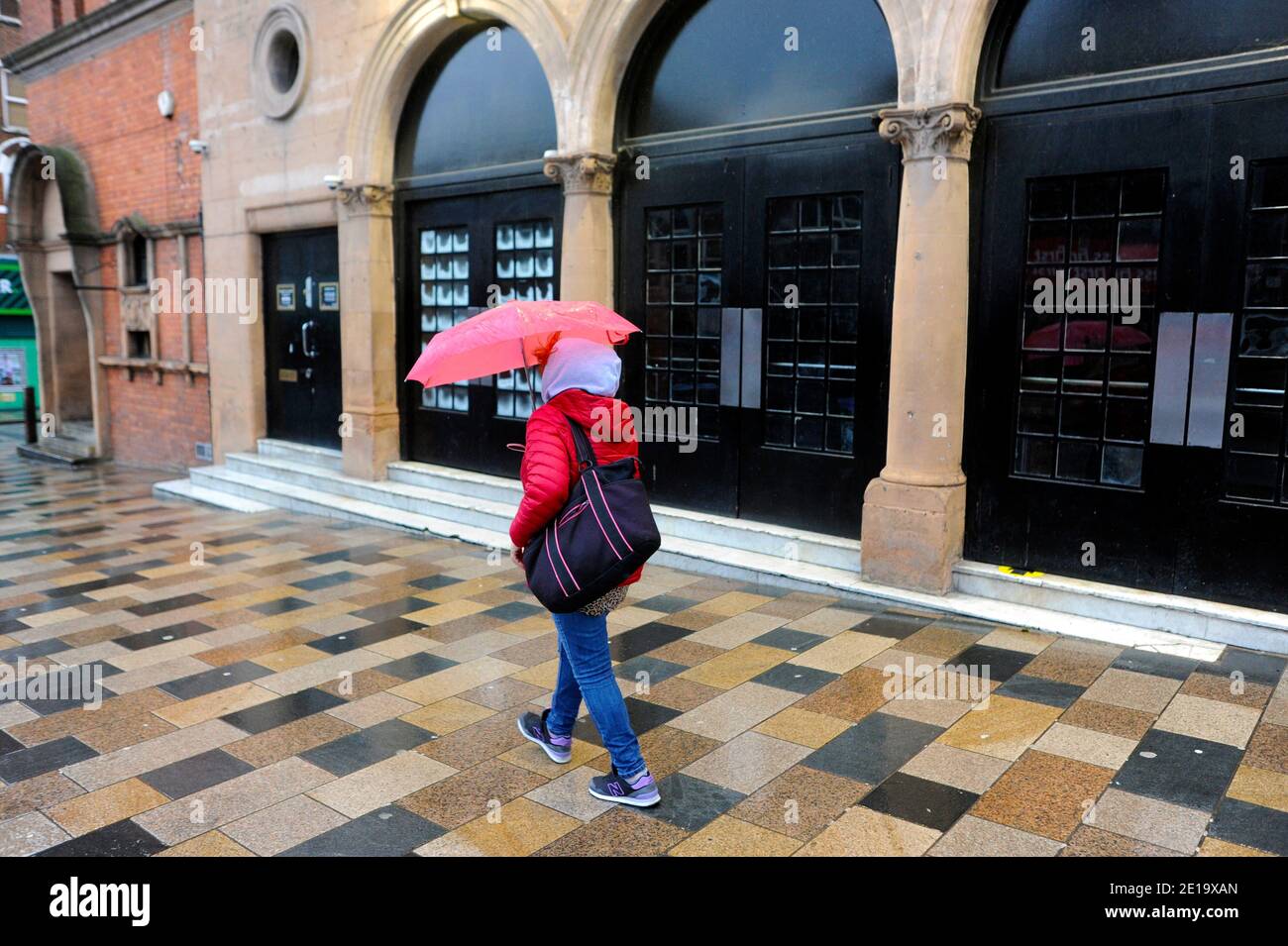 London, UK. 5th Jan, 2021. A woman walks past a shut The Grand opposite ...