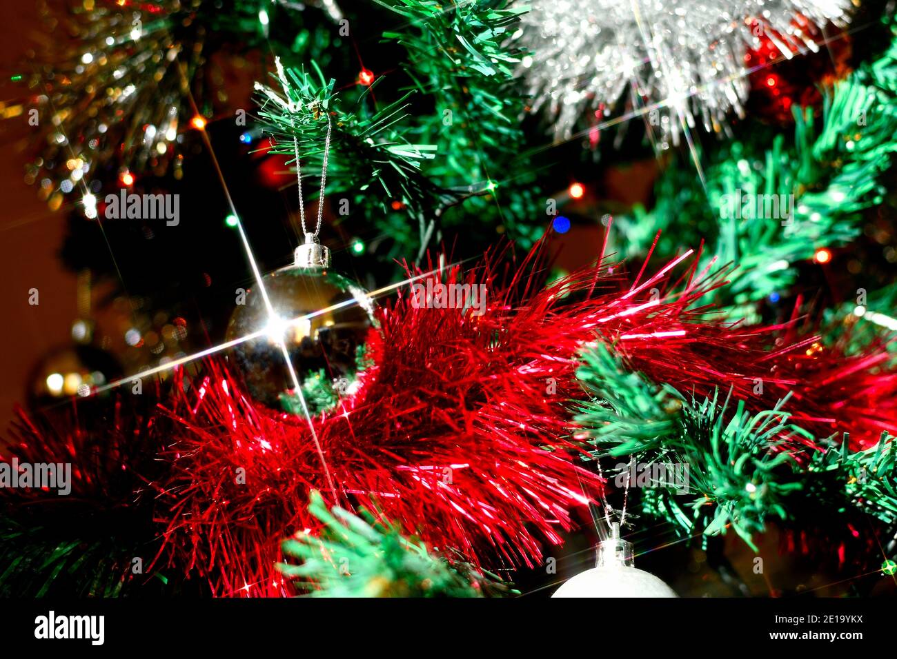Christmas tree with silver ball and lights Stock Photo - Alamy