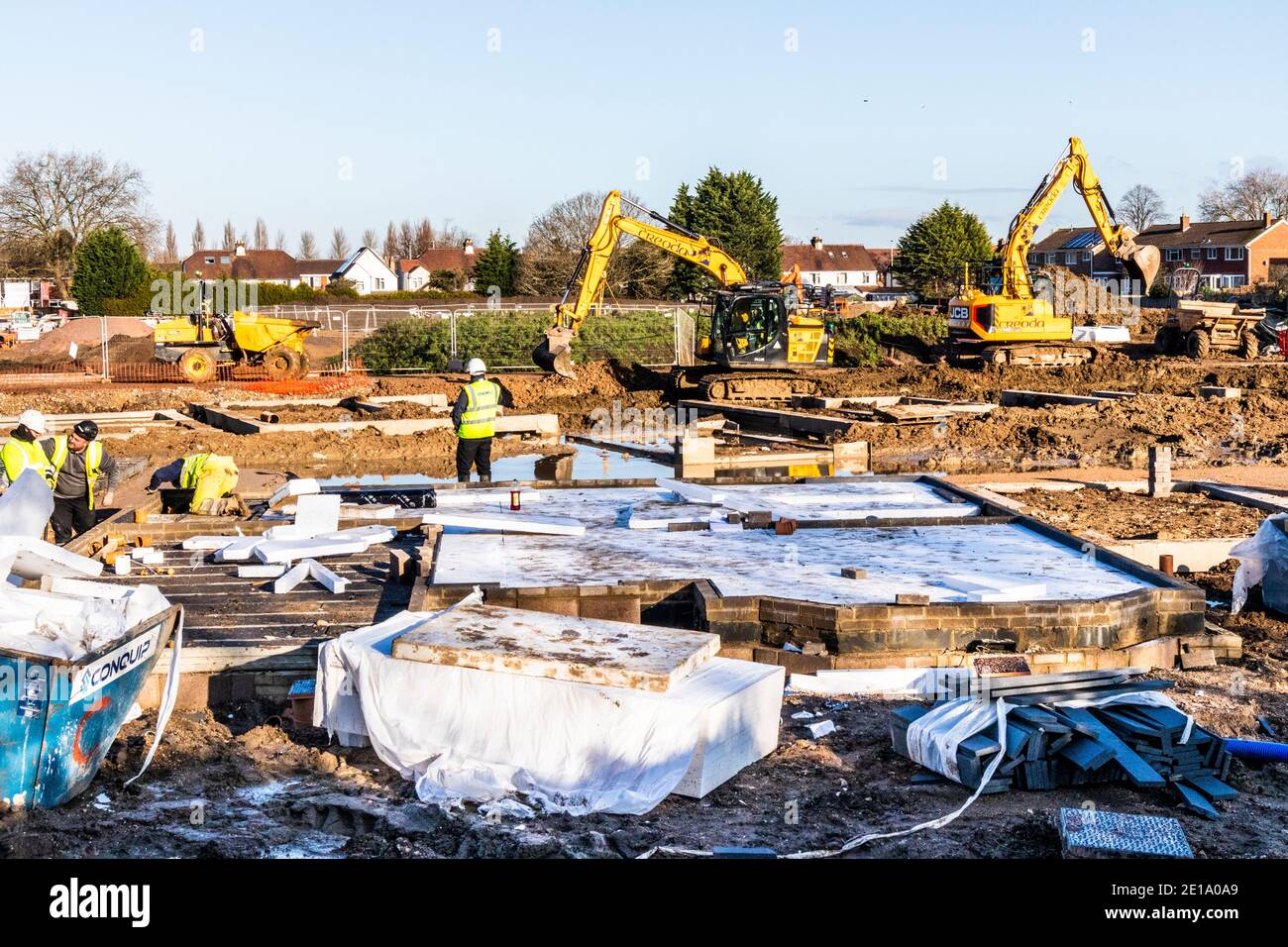 Insulation being installed to foundations for new houses being laid on ...