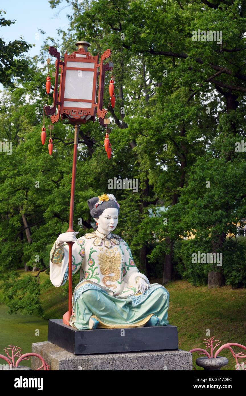 Zinc statue of Chinese woman sitting and holding Chinese lantern, at ...