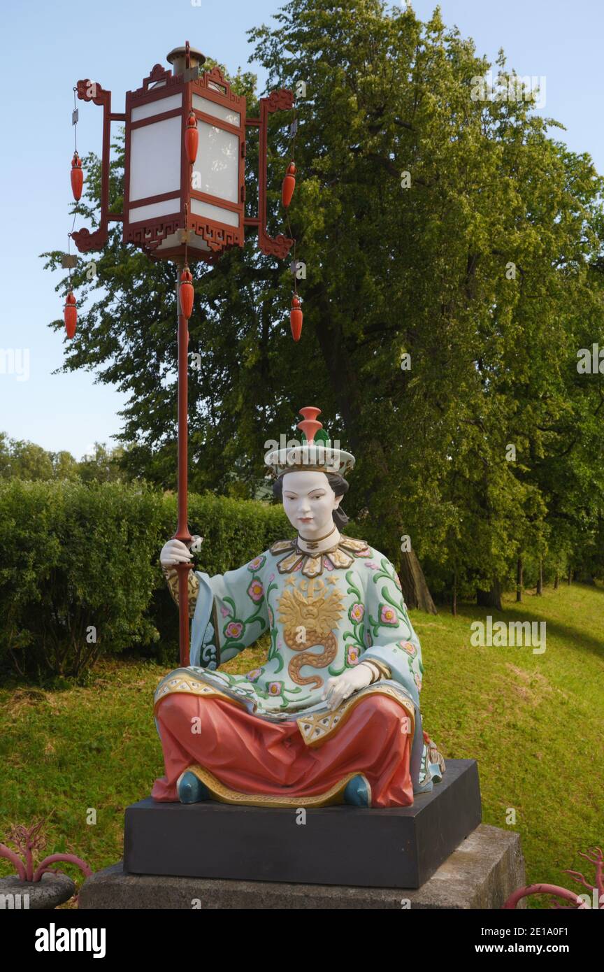 Zinc statue of Chinese woman sitting and holding Chinese lantern, at ...