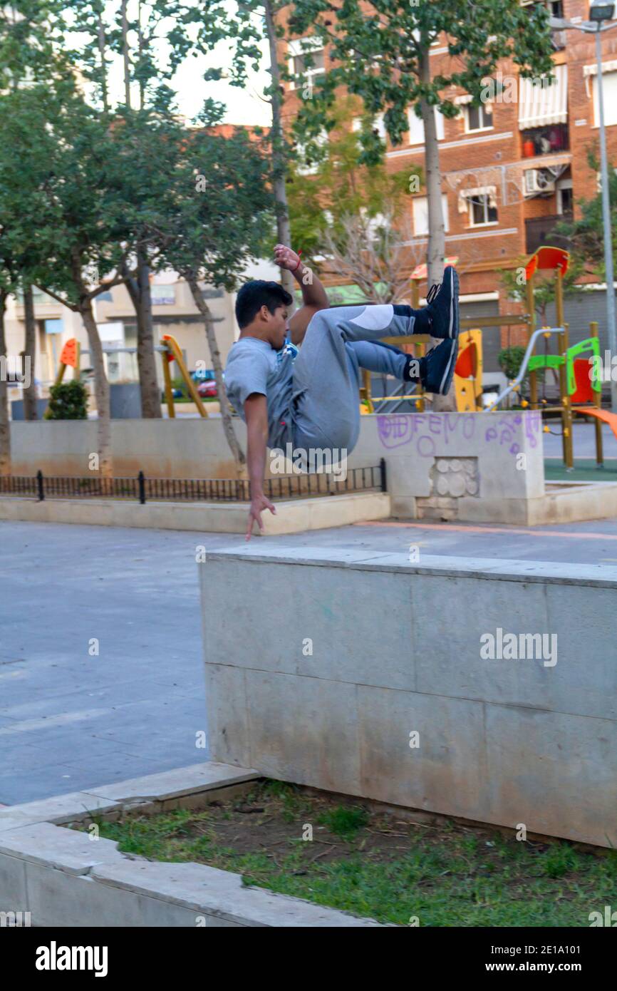 Active Latino young man jumping in action. Extreme sport activity ...