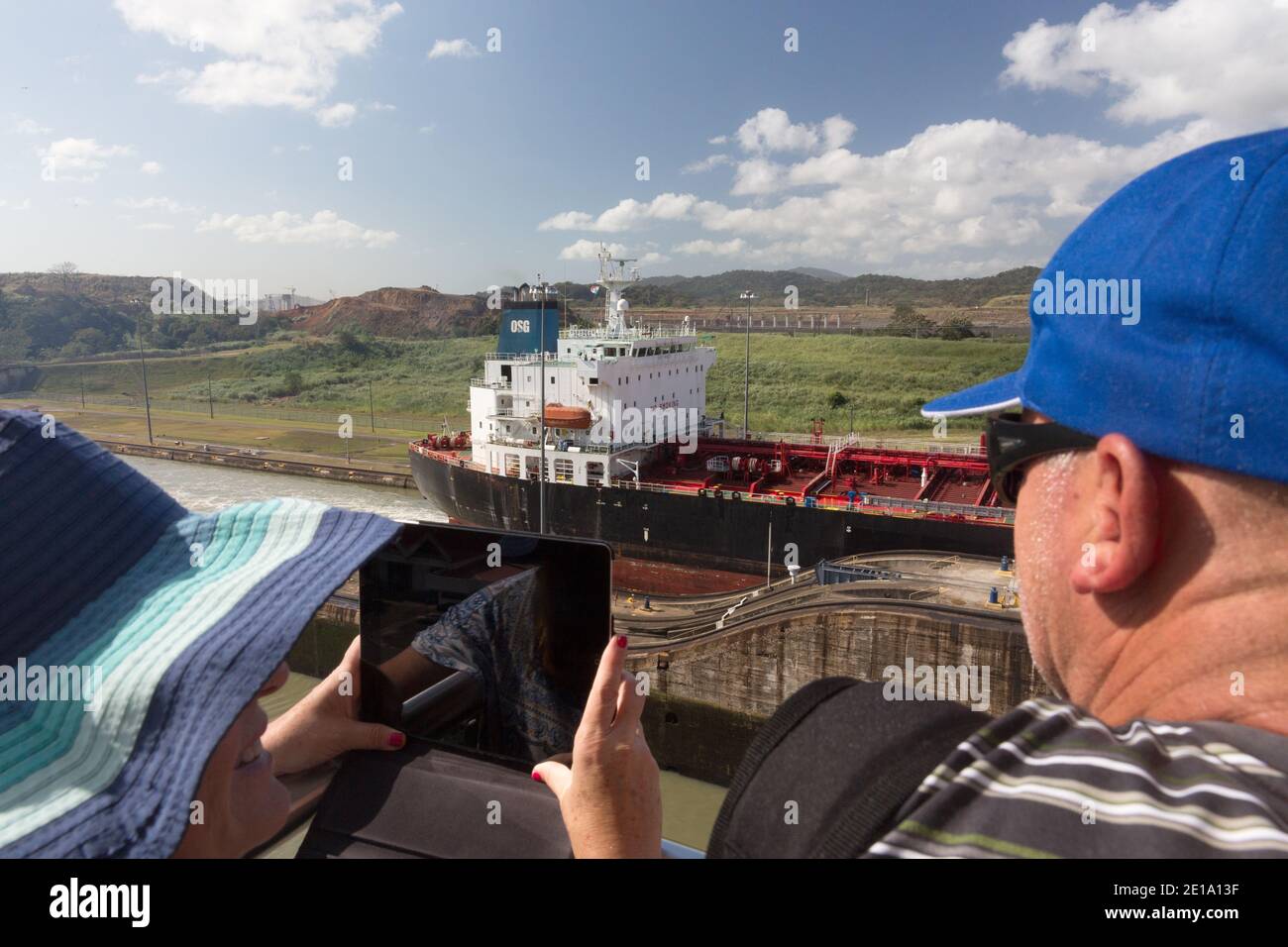 Visitors watch a tanker ship pass through the Miraflores Locks of the ...