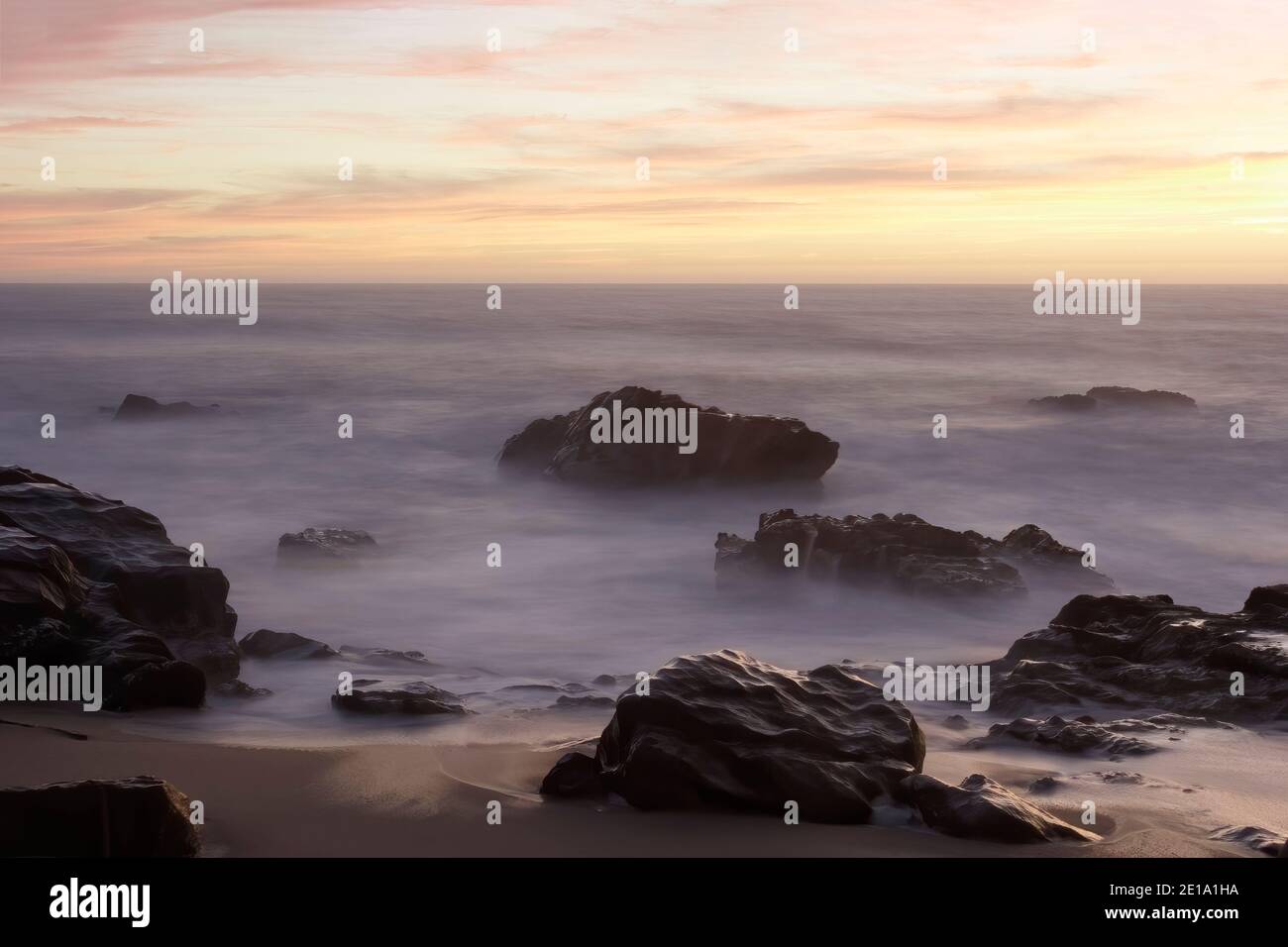 Colorful dusk in a rocky beach during low tide Stock Photo - Alamy
