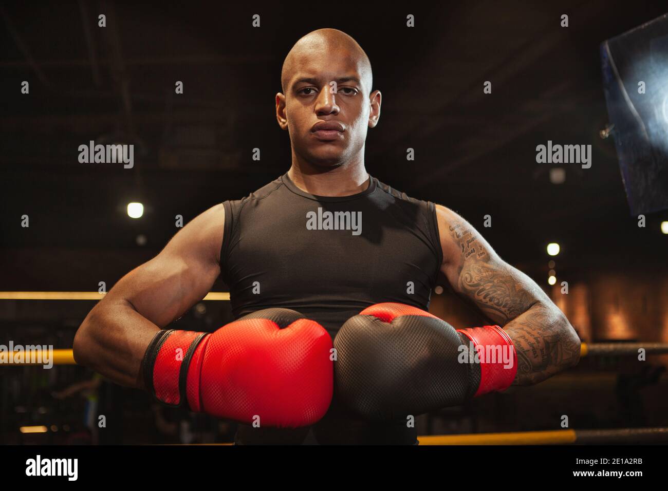 Confident serious African boxing fighter looking fiercely to the camera ...
