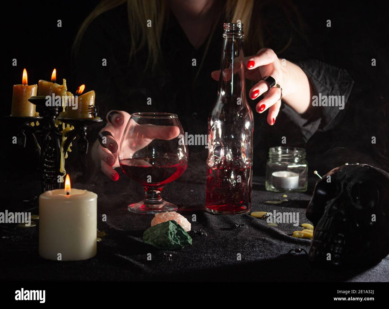 The witch's hand holds a bottle with a red liquid in the shape of a ...