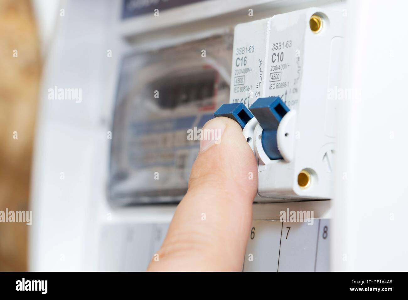 The hand points to a fuse in the power meter. The man disables the ...
