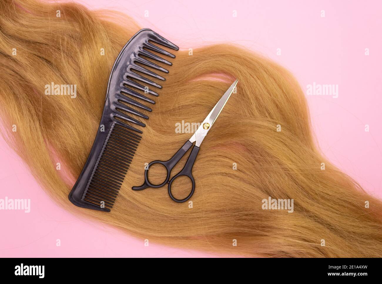 Hair, scissors and comb on a pink background, top view. hair salon ...