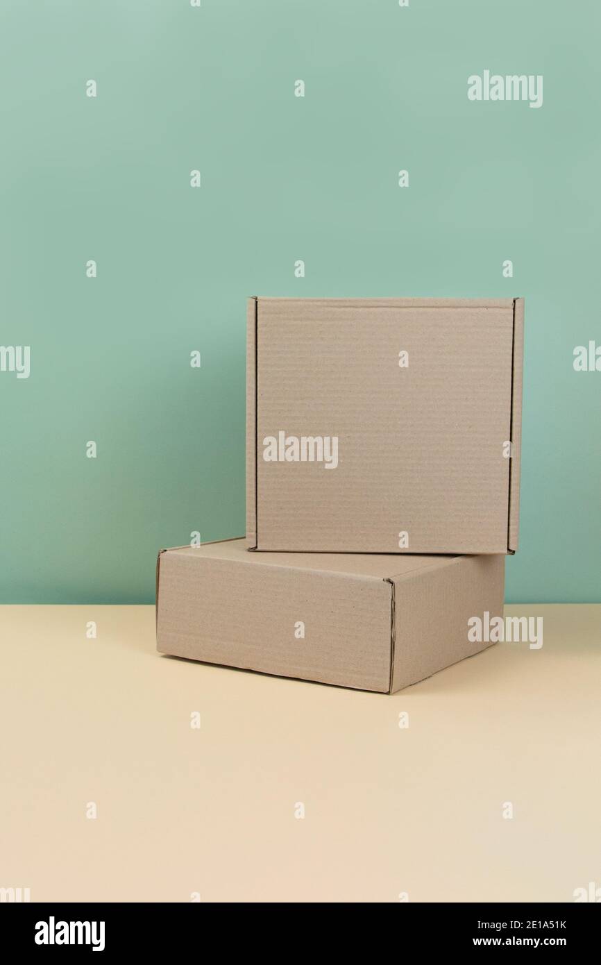 Stack of Brown cardboard boxes on mint background. Blank carton box ...