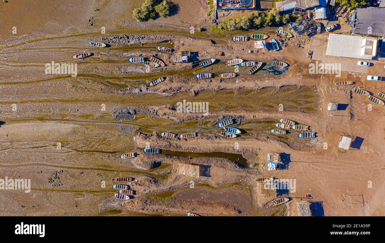 Aerial view of fishing boats in the mud or mud of the estuary in the ...