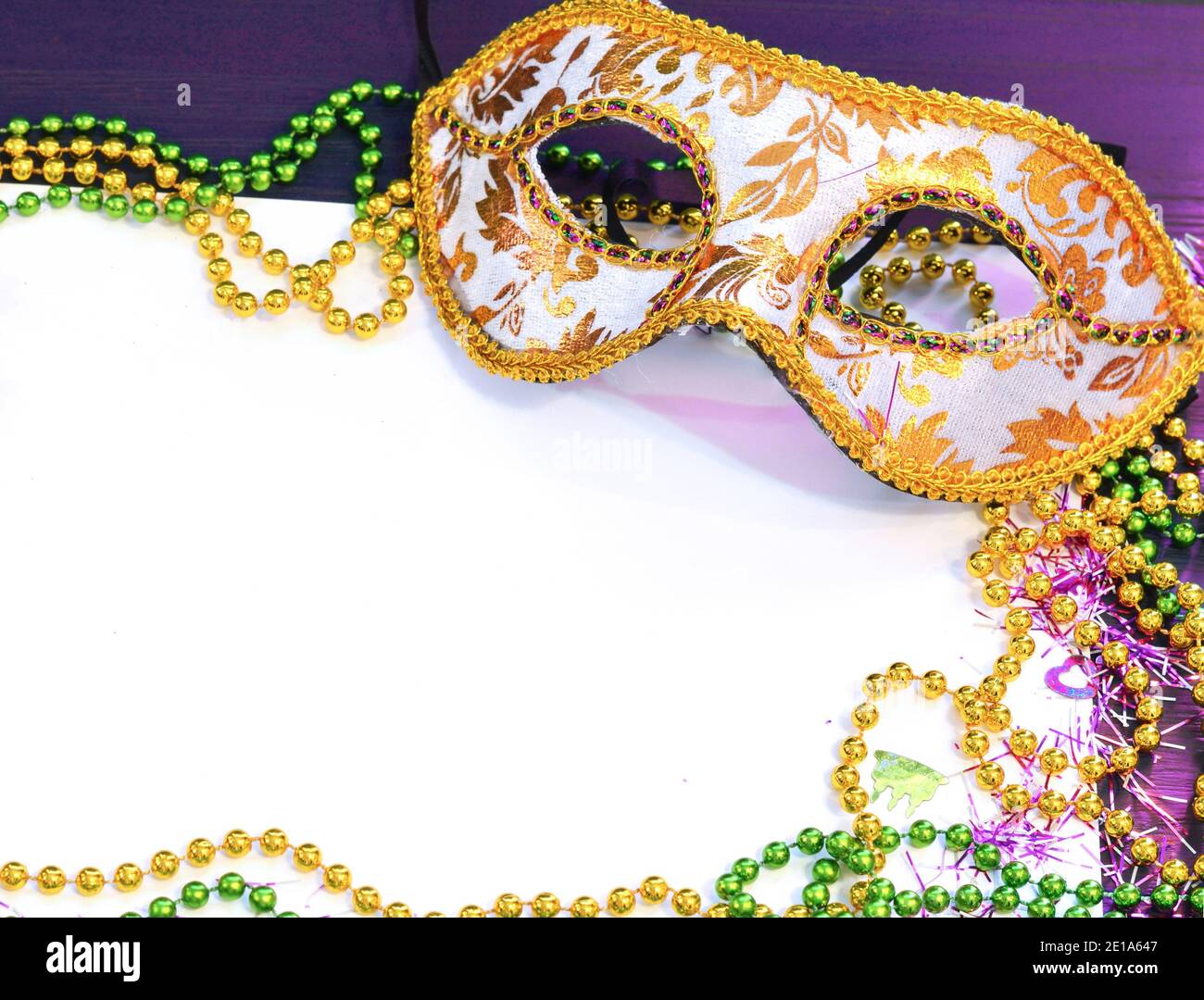 Mardi gras mask and beads frame for text on white space background ...