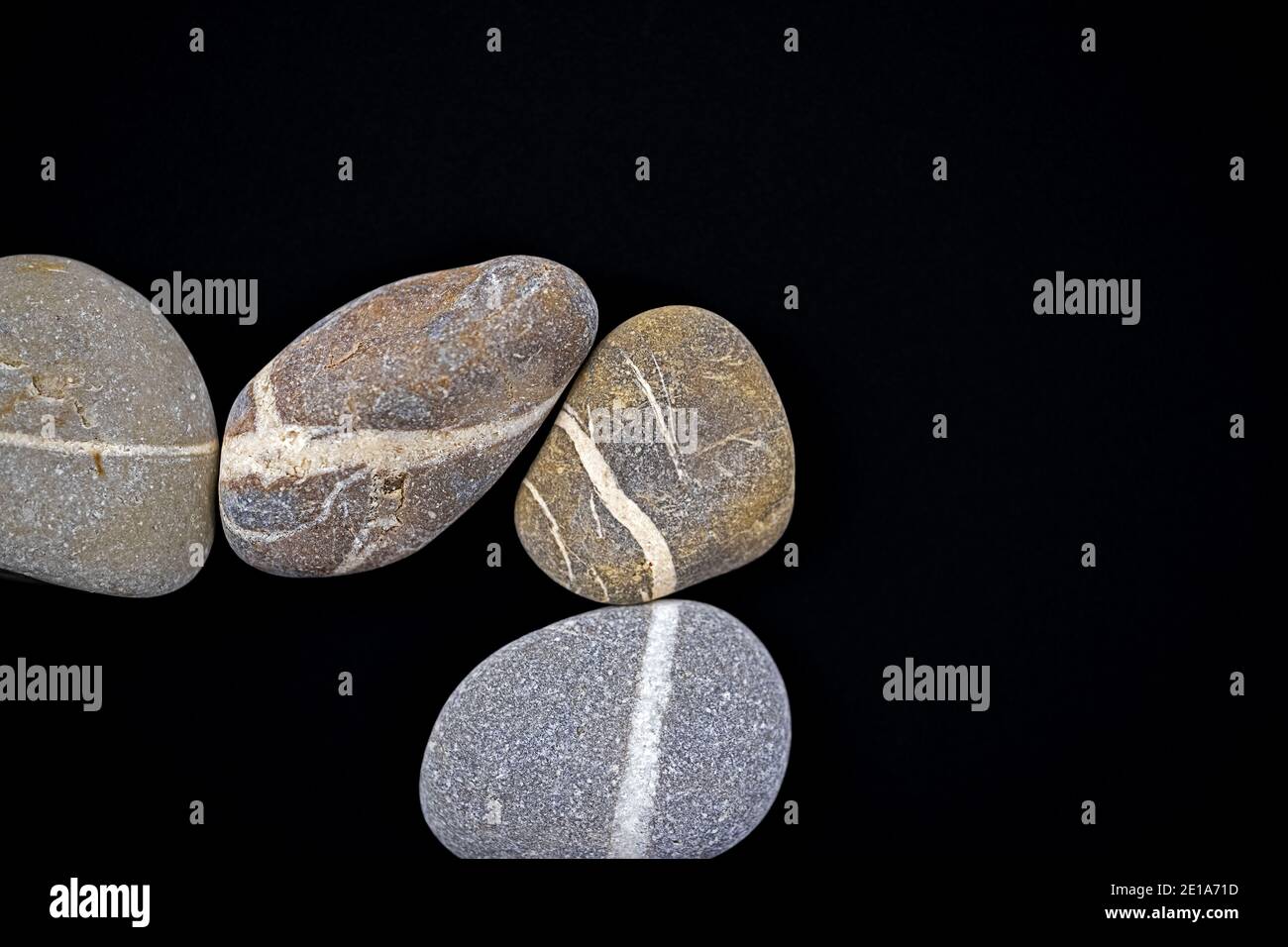 Pebbles with white lines arranged in an arc on a black background Stock ...