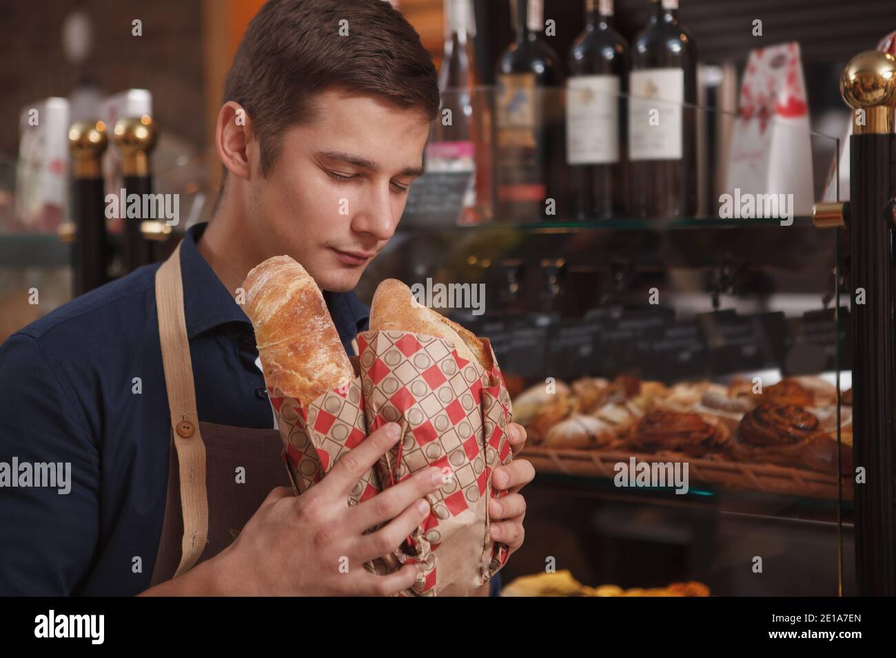Attractive male baker smelling hi-res stock photography and images - Alamy