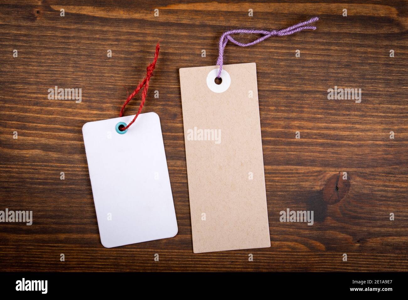 Cardboard and white paper price tags on a wooden texture background ...