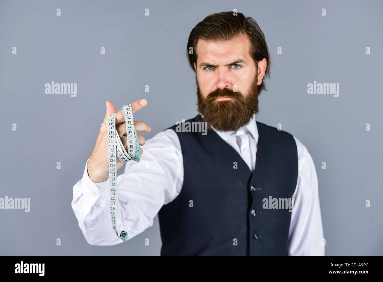 Talented tailor. man tailor with tape measure and scissors. man ...