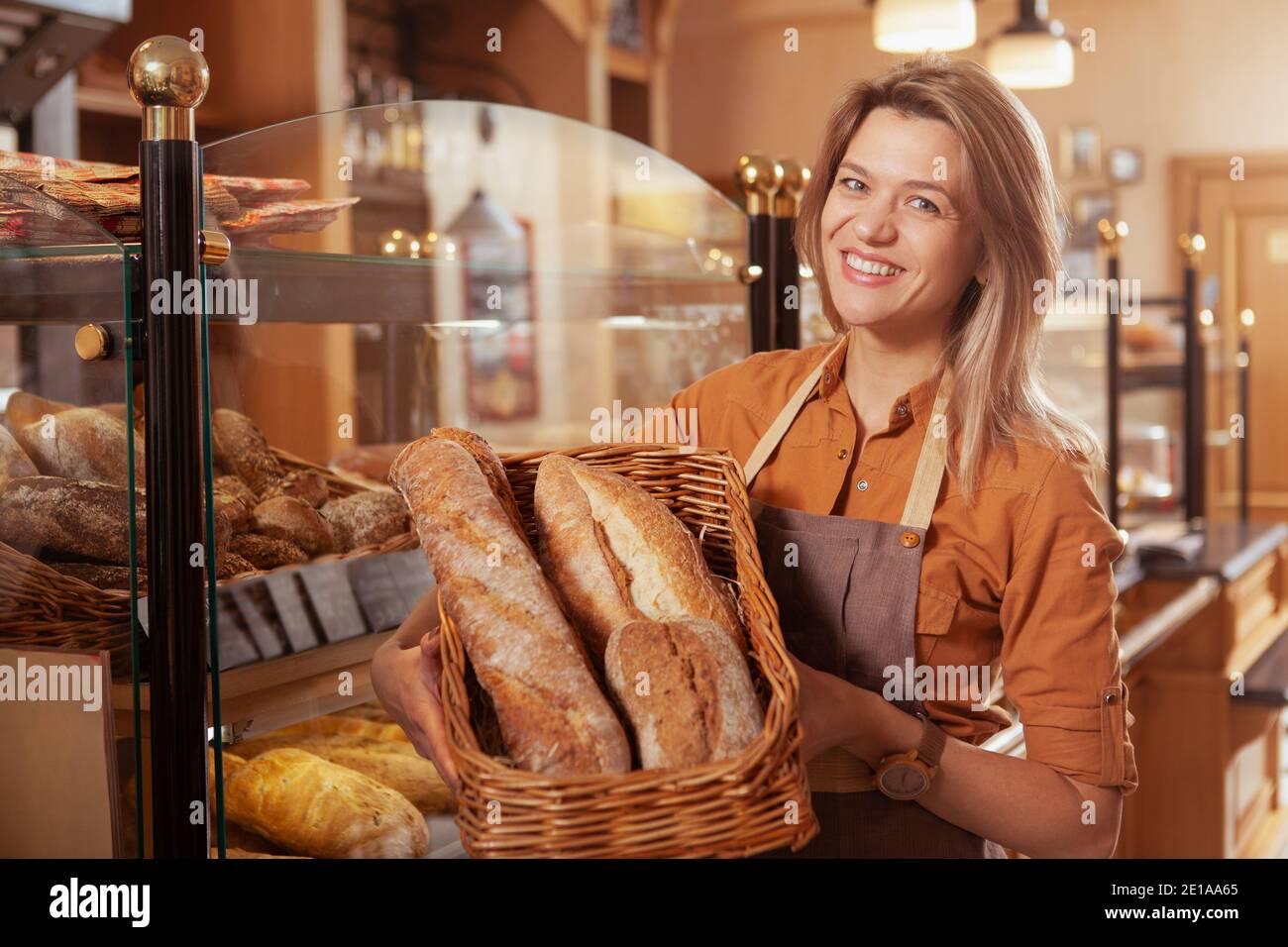 Proud female entrepreneur selling selicious bread at her bakery. Female ...