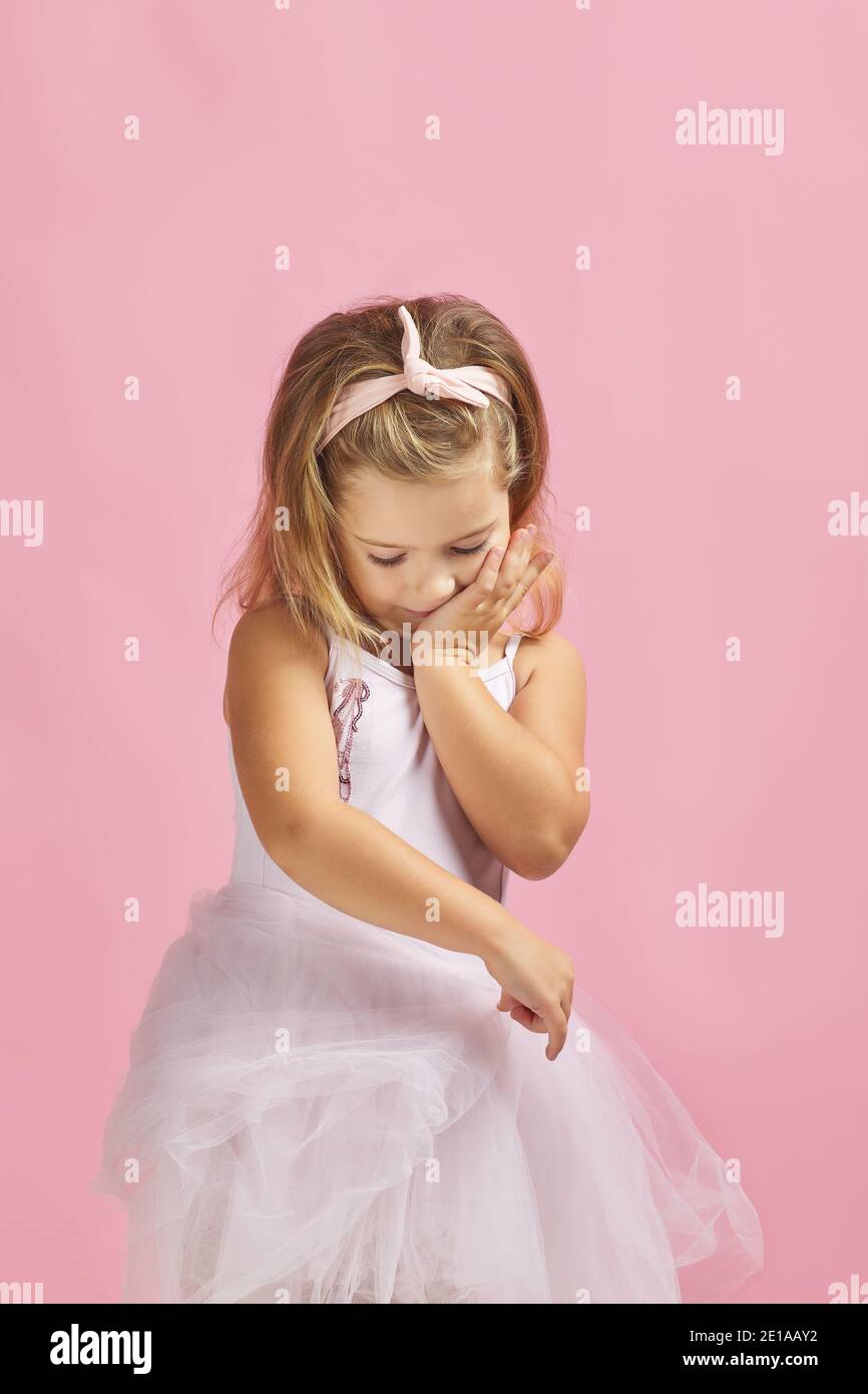 shy little child girl dreams of becoming a ballerina. ballet dancer in ...